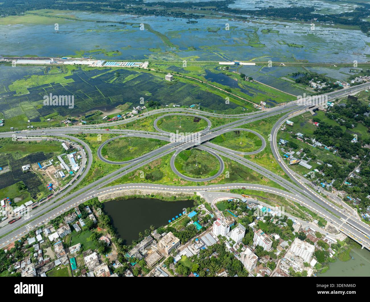 Aerial view of a cloverleaf interchange with its looping ramps cutting ...