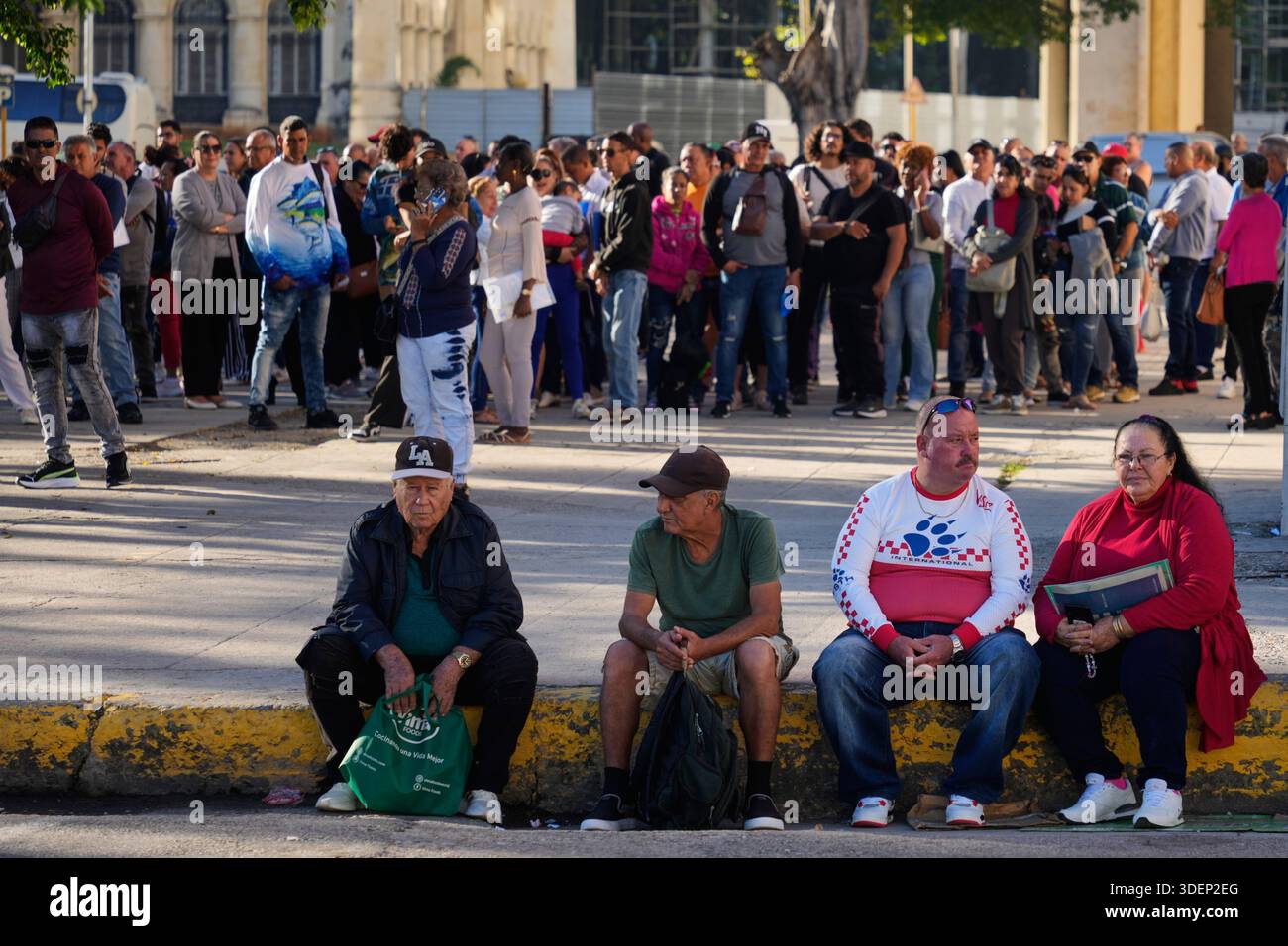 Cubans wait their turn at the Spanish embassy in Havana, Cuba, on ...