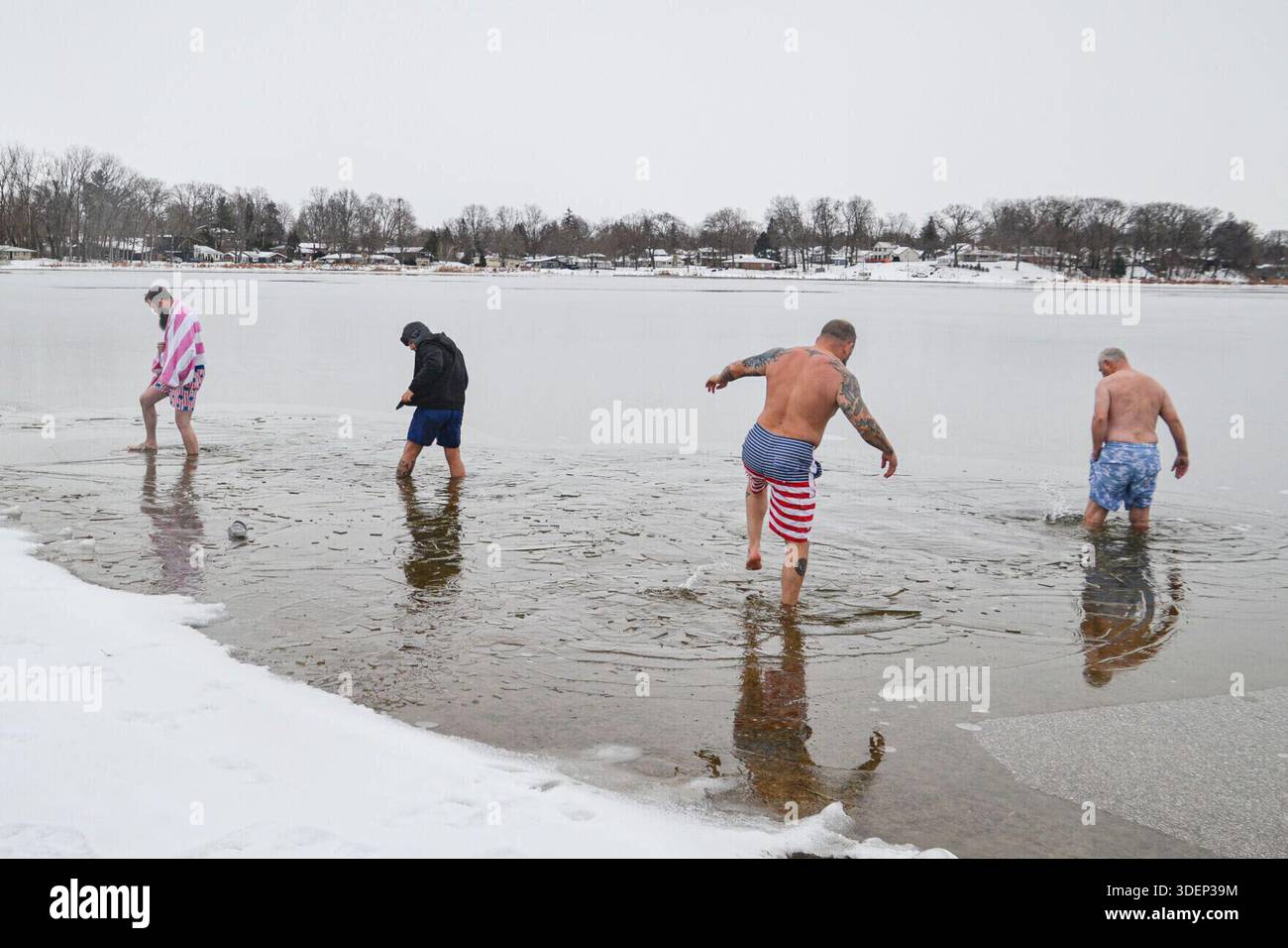 Polar Plunge participants break up ice along Stone Lake Beach in La ...