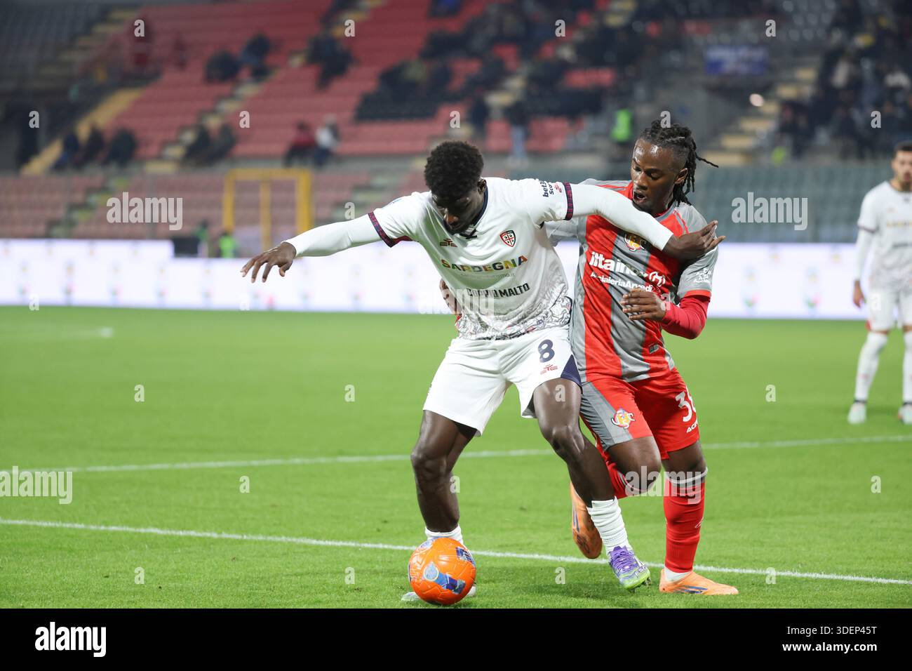 Cagliari's Ndary Michel Adopo and Cremonese's Warren Bondo during the ...