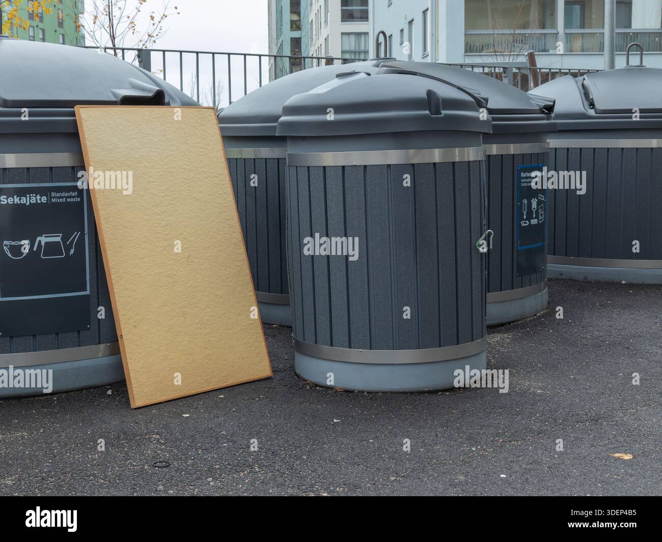 A row of deep-collection waste containers in a residential area, with ...