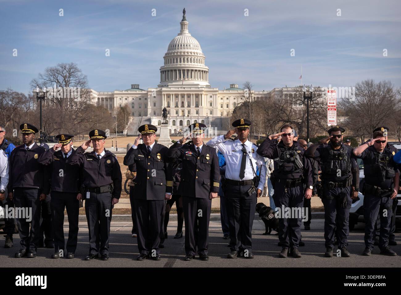 U.S. Capitol Police officers salute as a van carrying the body of ...