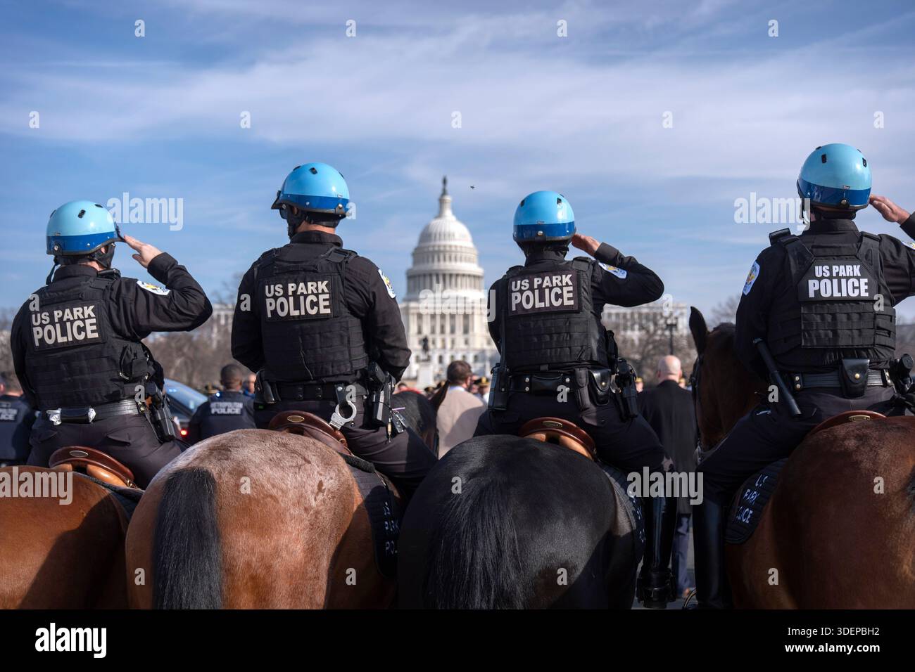 U.S. Park Police mounted officers salute as a van carrying the body of ...