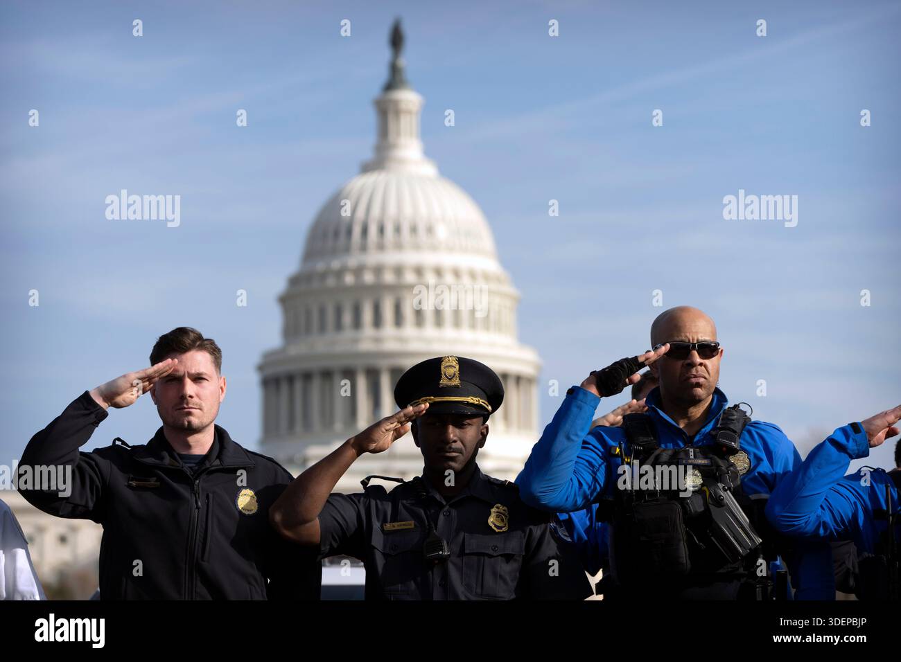 U.S. Capitol Police officers salute as a van carrying the body of ...