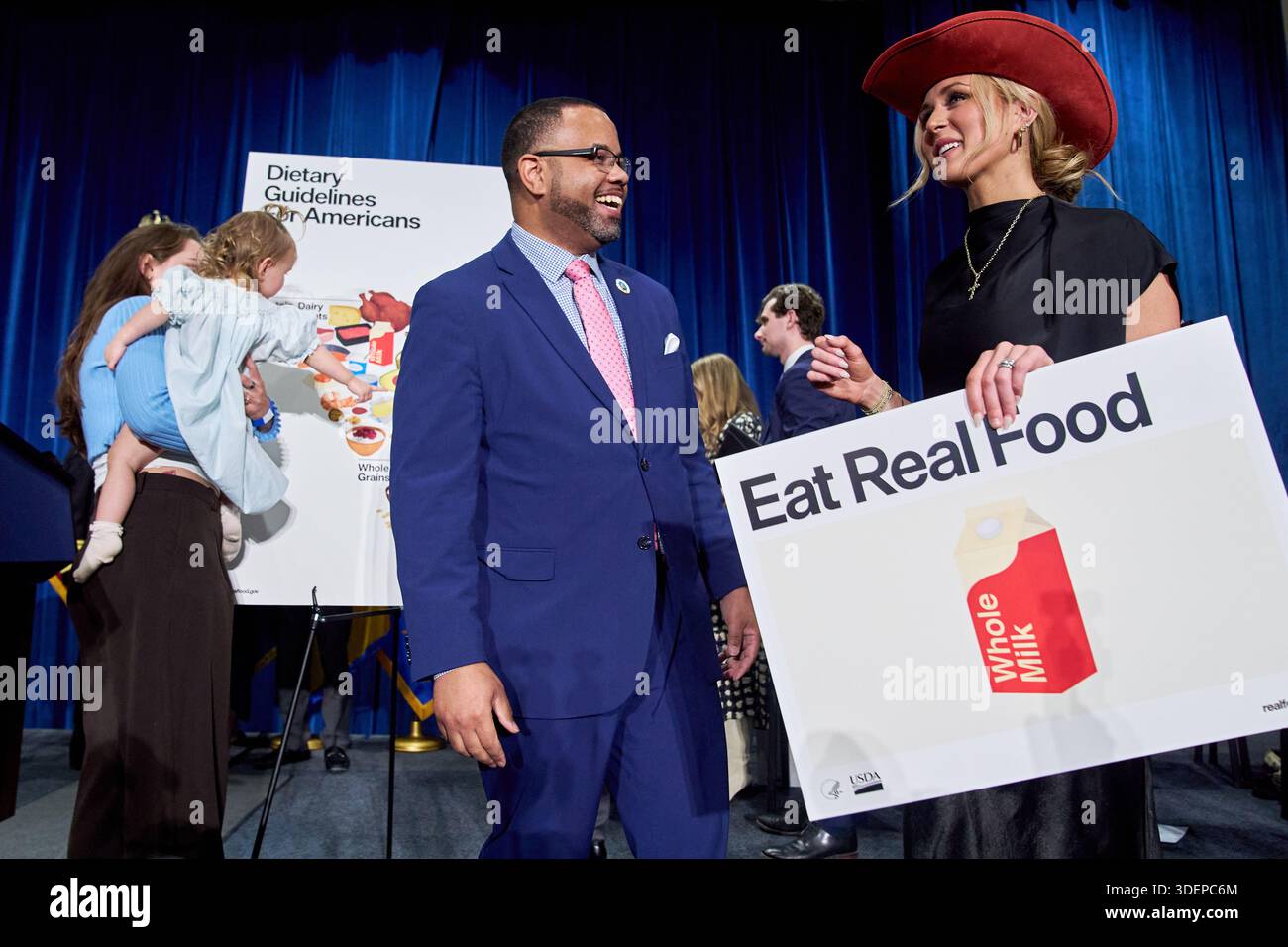 Conservative political activist Riley Gaines, right, holds sign with an ...
