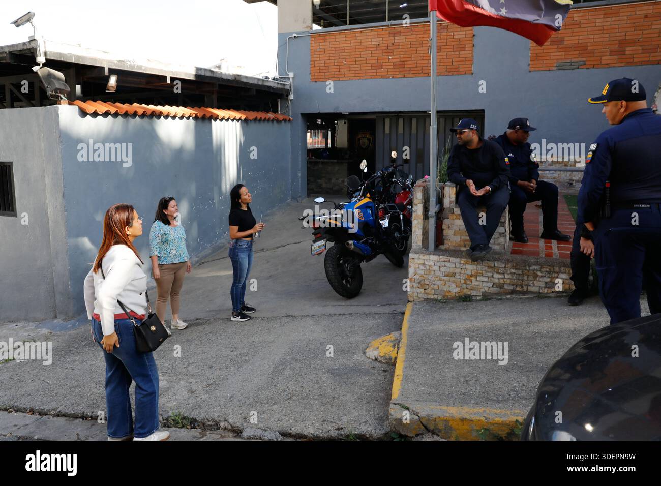 Relatives arrive at Zone 7 of the Bolivarian National Police, where ...