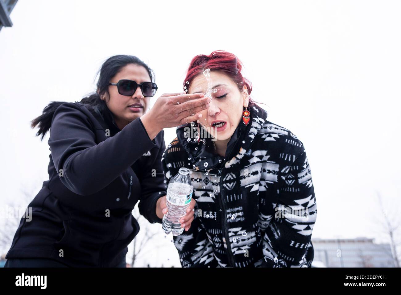 A community worker helps a person who came into contact with chemical ...