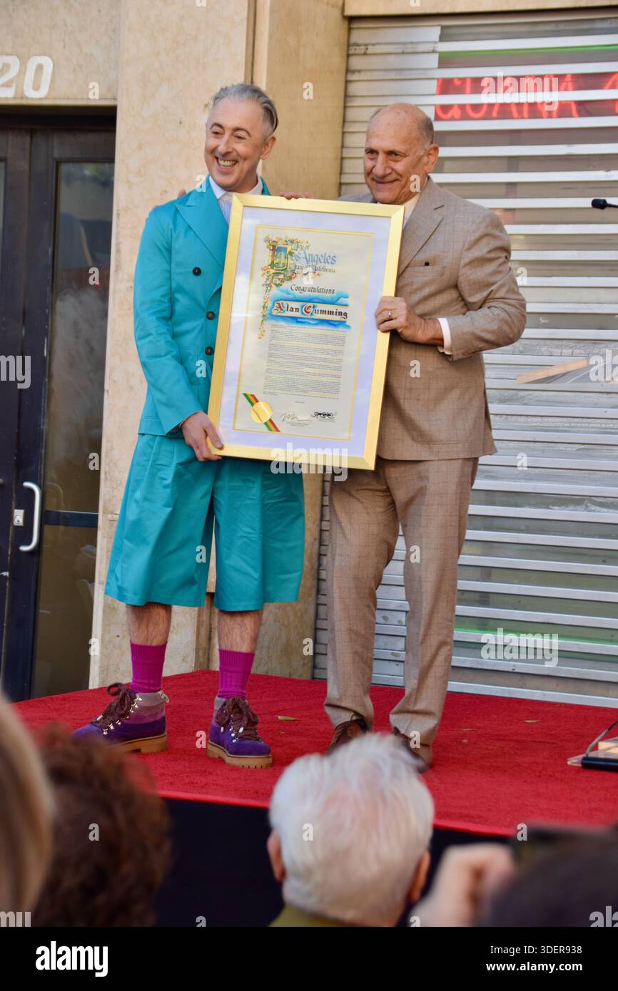 Steve Nissen presents a proclamation to Alan Cumming during his ...