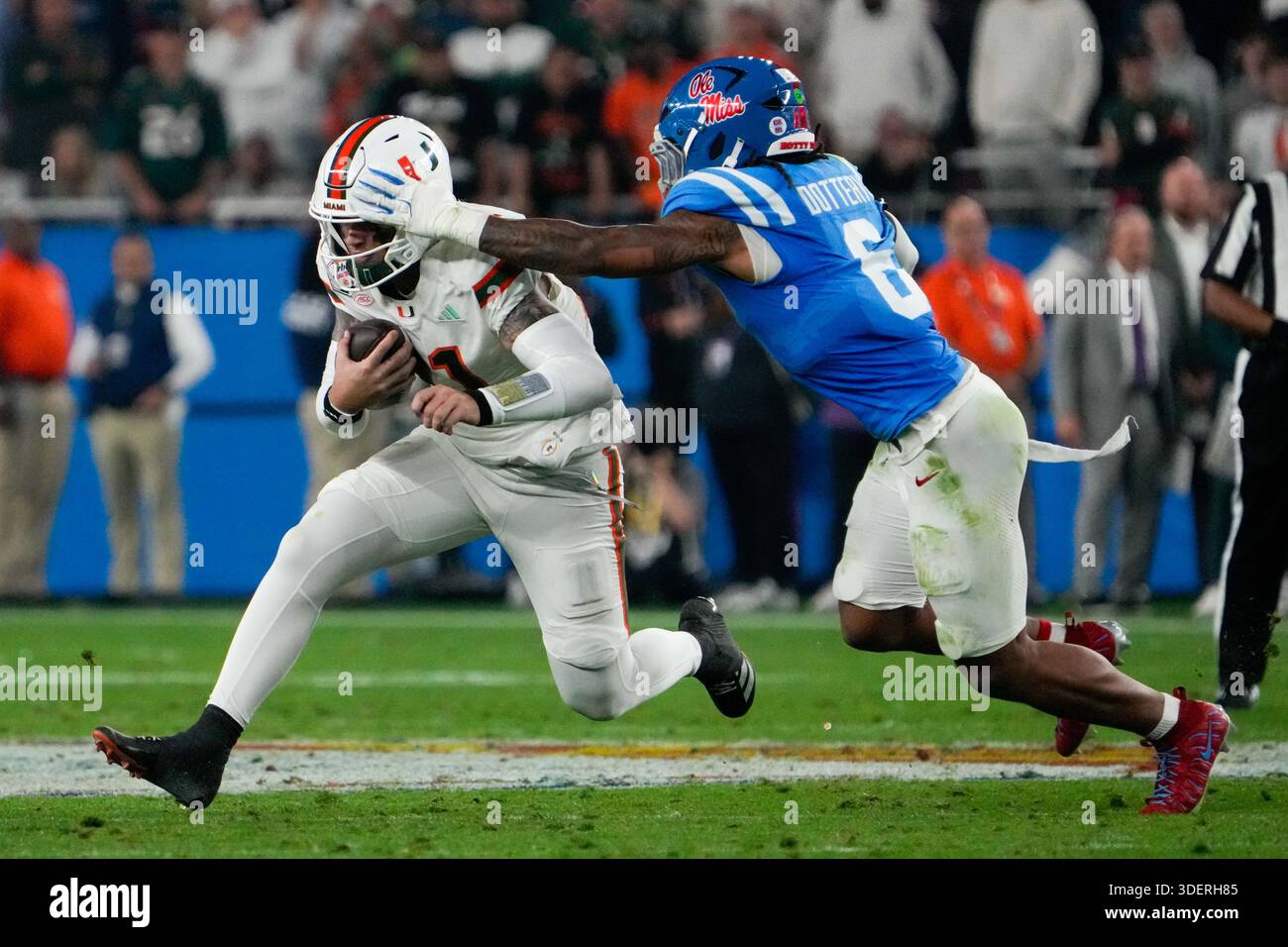 Miami Hurricanes quarterback Carson Beck (11) is tackles by Ole Miss ...