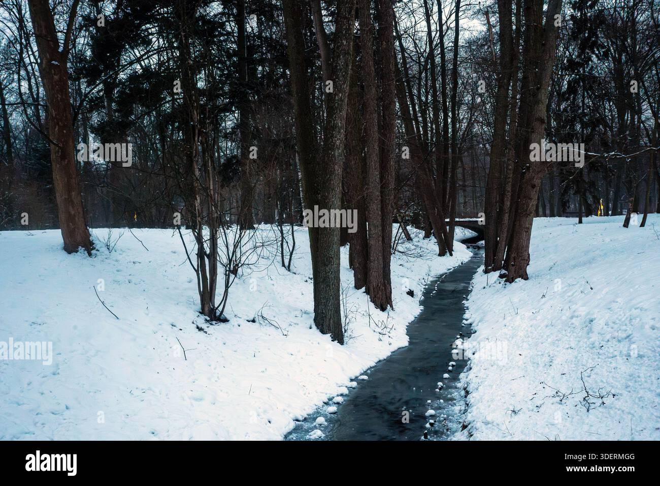 A frozen stream stretches towards a bridge in the distance. Photographs ...