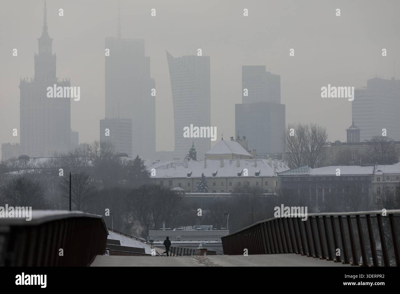 Warsaw skyscrapers are visible through haze from a pedestrian and ...
