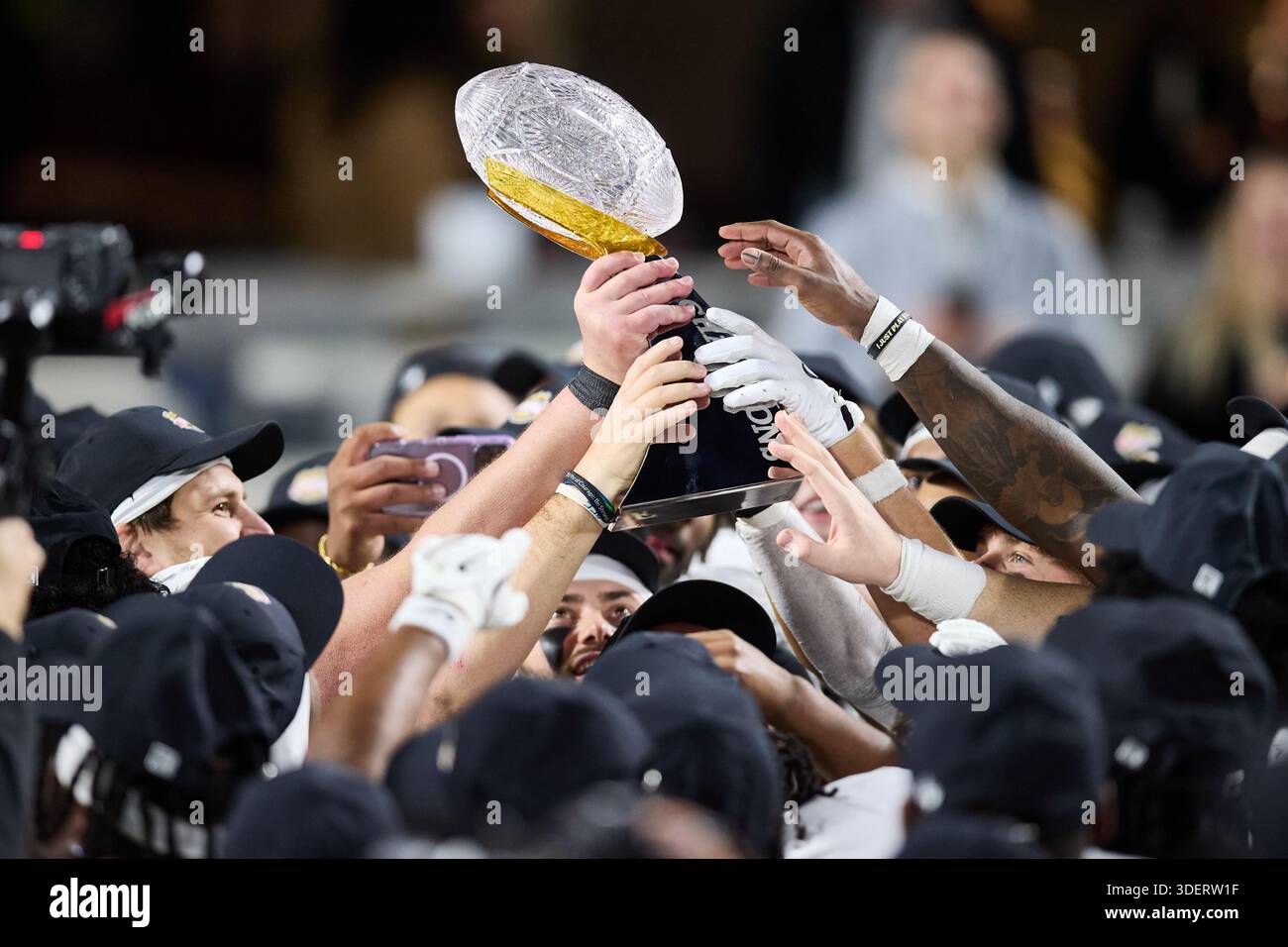 The Wake Forest team touches the trophy following the Duke's Mayo Bowl ...
