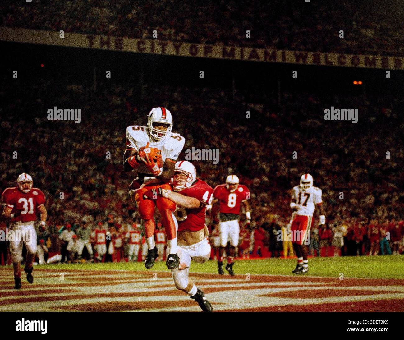 FILE -Miami wide receiver Kevin Williams (5) cradles a Gino Torretta ...