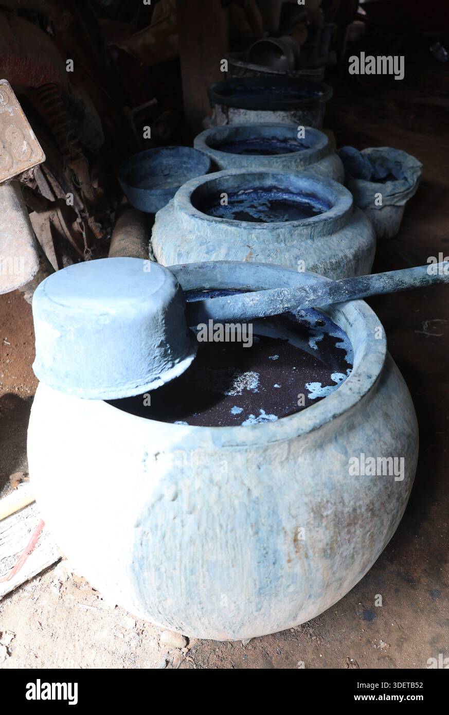 Indigo in earthenware pots for traditional textile weaving by the Lao ...