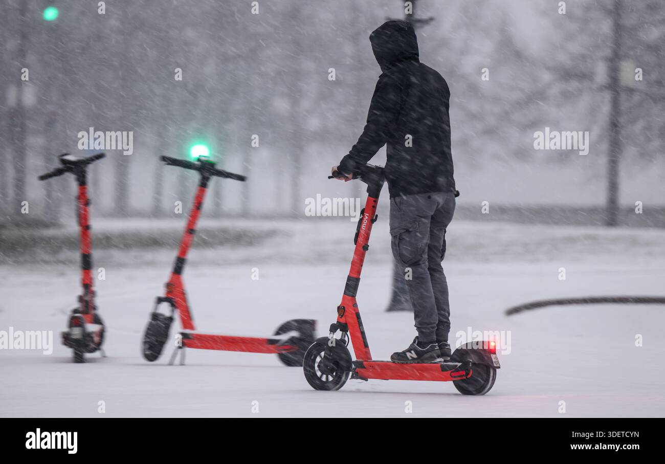 Dresden, Germany. 09th Jan, 2026. A man rides an e-scooter across ...