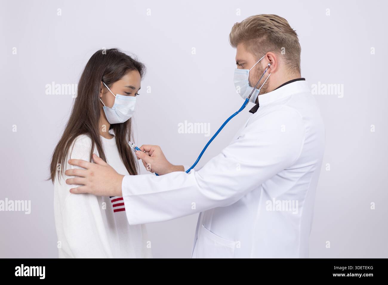 Nurse using a stethoscope to listen to a patient's lungs Stock Photo ...