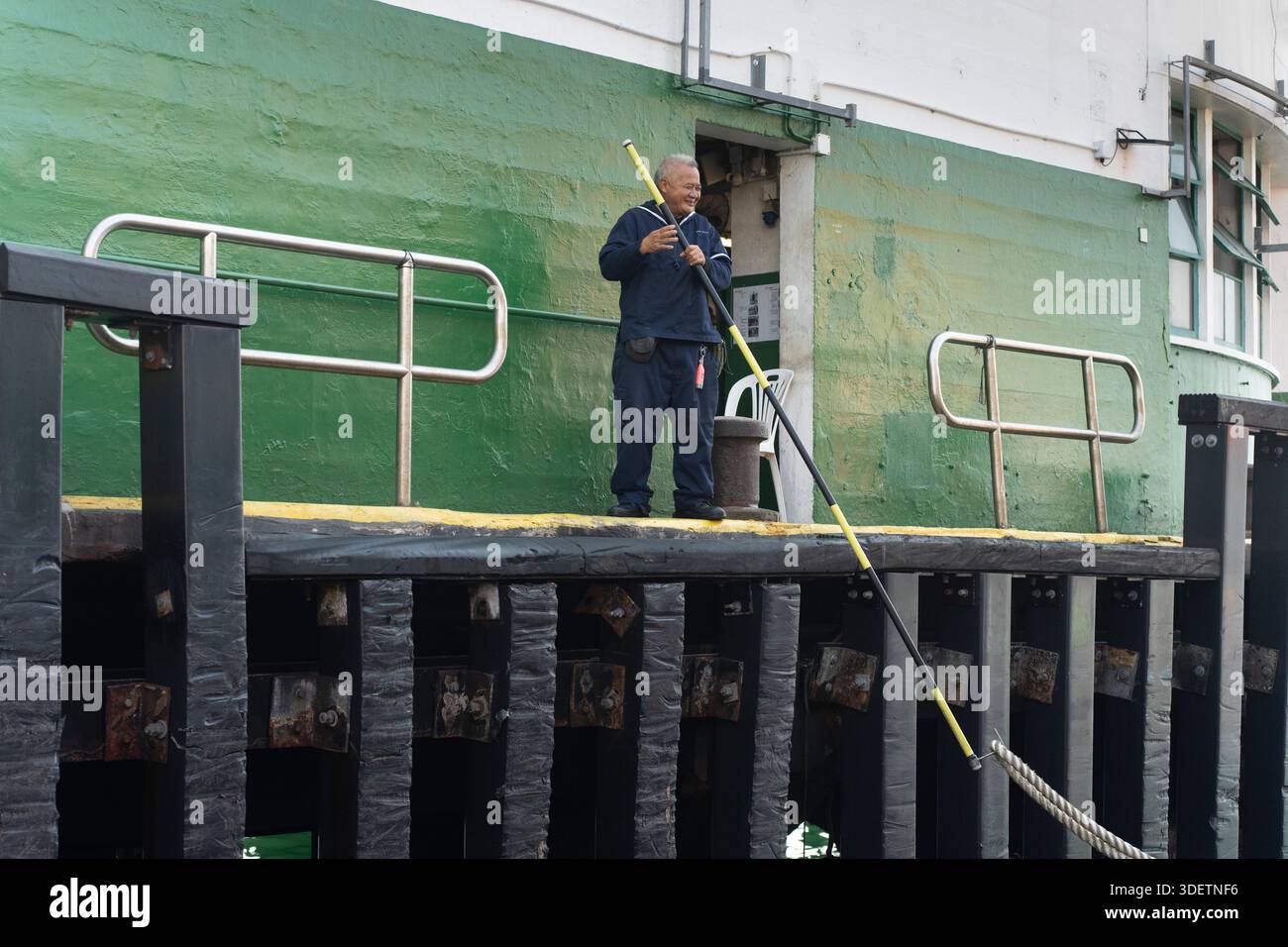 A ferry worker prepares to dock at the Star Ferry Pier in Hong Kong ...