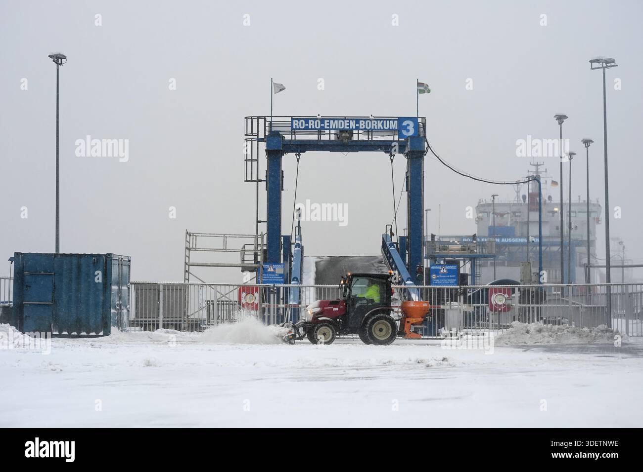 09 January 2026, Lower Saxony, Emden: An AG-Ems employee clears snow in ...