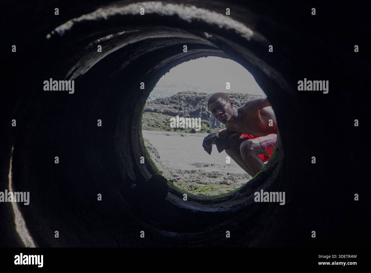A man looks into a tunnel at the port in Mogadishu, Somalia, Thursday ...