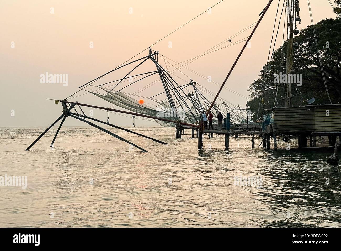 Traditional Chinese fishing nets line the waterfront in Kochi, Kerala ...