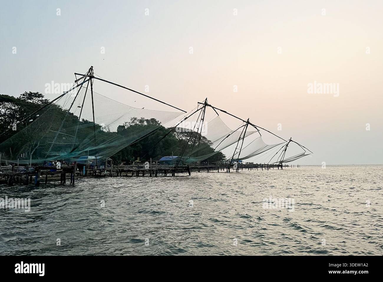Traditional Chinese fishing nets line the waterfront in Kochi, Kerala ...