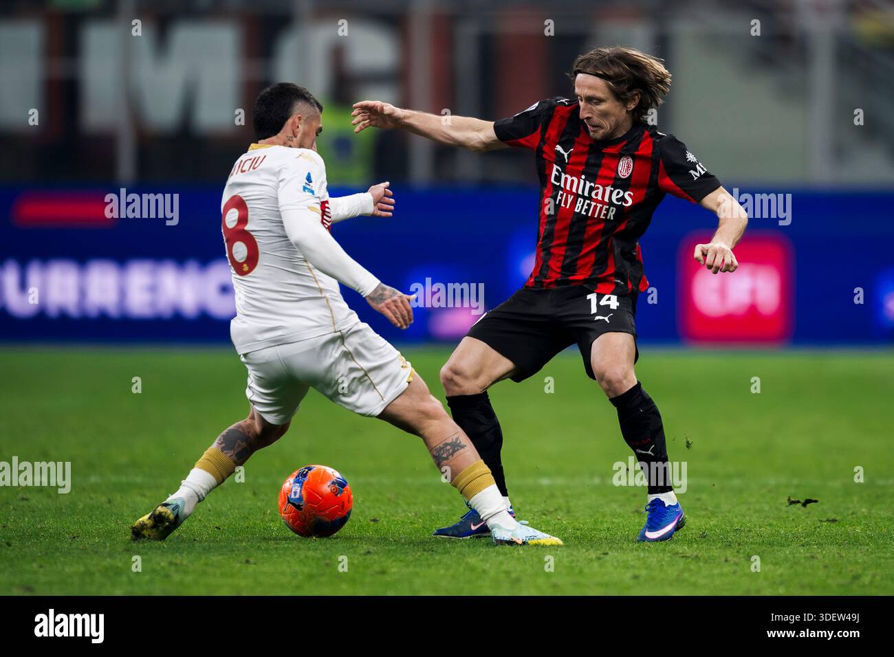 Luka Modric of AC Milan competes for the ball with Nicolae Stanciu of ...