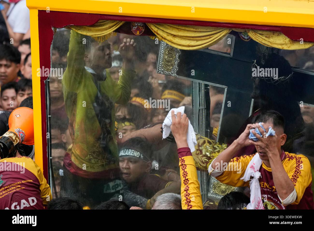 A Catholic devotee kisses the glass of the carriage carrying the image ...