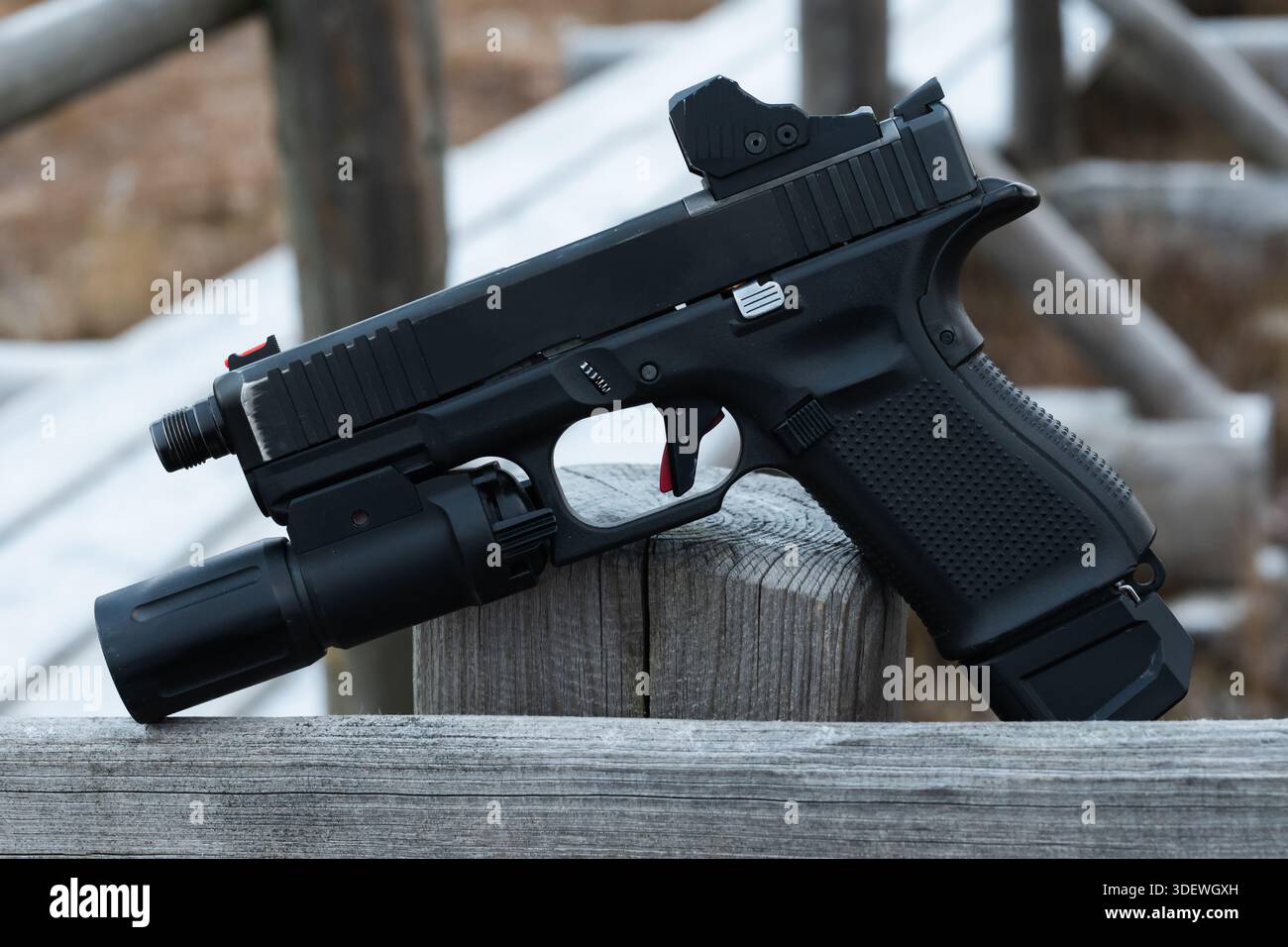 Modern semi-automatic tactical pistol with red dot sight and flashlight ...