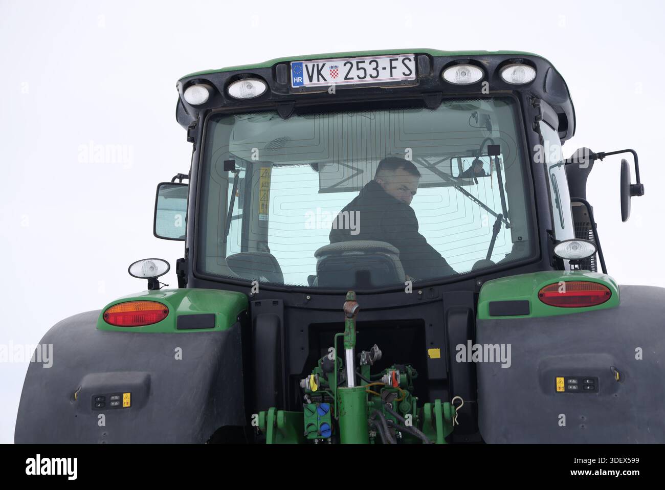A tractor pulls people on a boat sled at snow covered field in Vinkovci ...