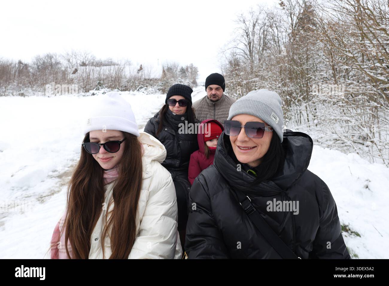 A tractor pulls people on a boat sled at snow covered field in Vinkovci ...