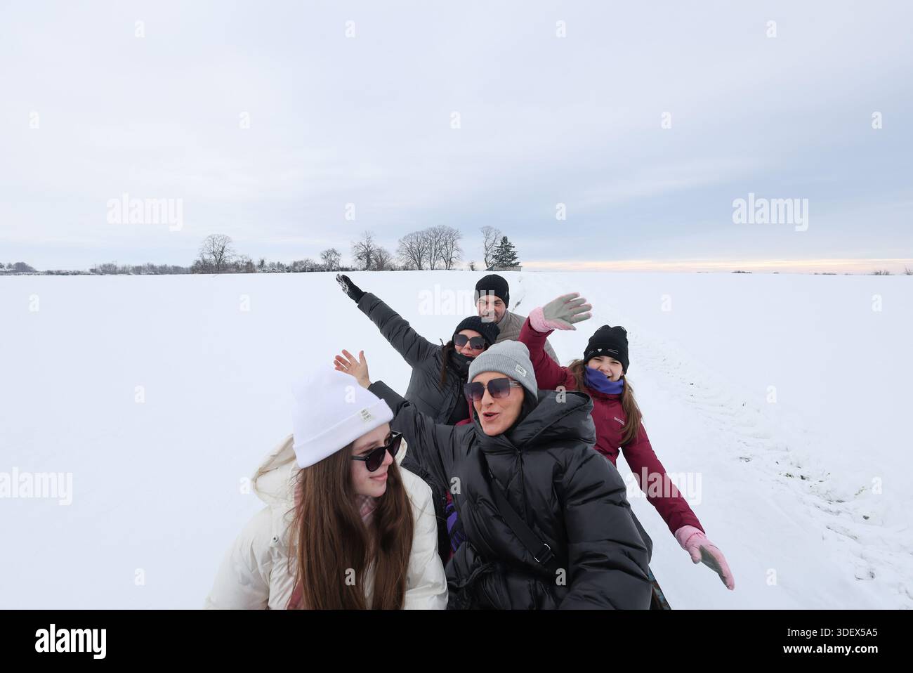 A tractor pulls people on a boat sled at snow covered field in Vinkovci ...