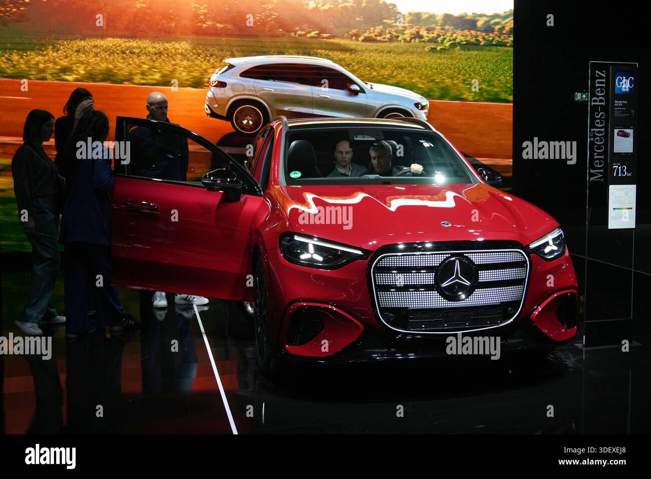 Visitors sit inside the Mercedes GLC electric car at its world premiere ...