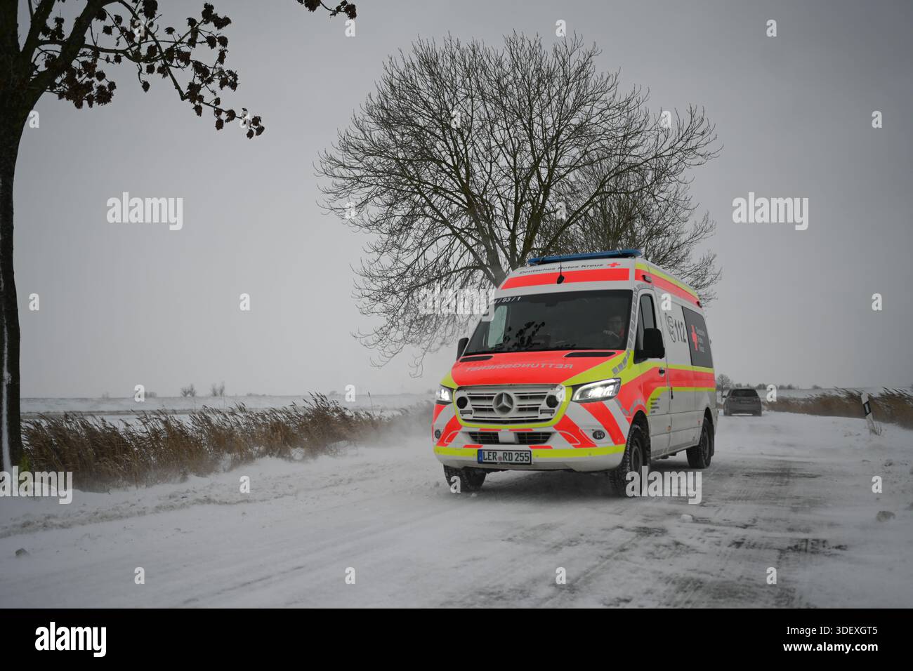 09 January 2026, Lower Saxony, Dever: An ambulance drives over a snow ...
