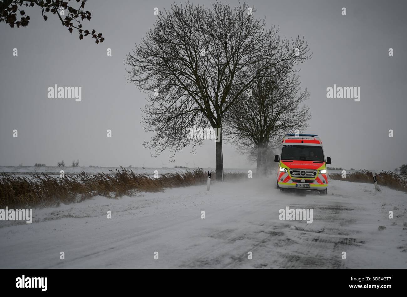 09 January 2026, Lower Saxony, Dever: An ambulance avoids snowdrifts ...