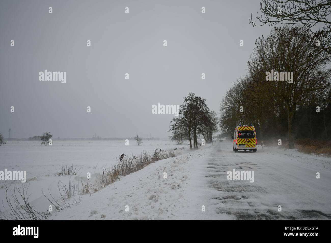 09 January 2026, Lower Saxony, Dever: An ambulance drives over a snow ...