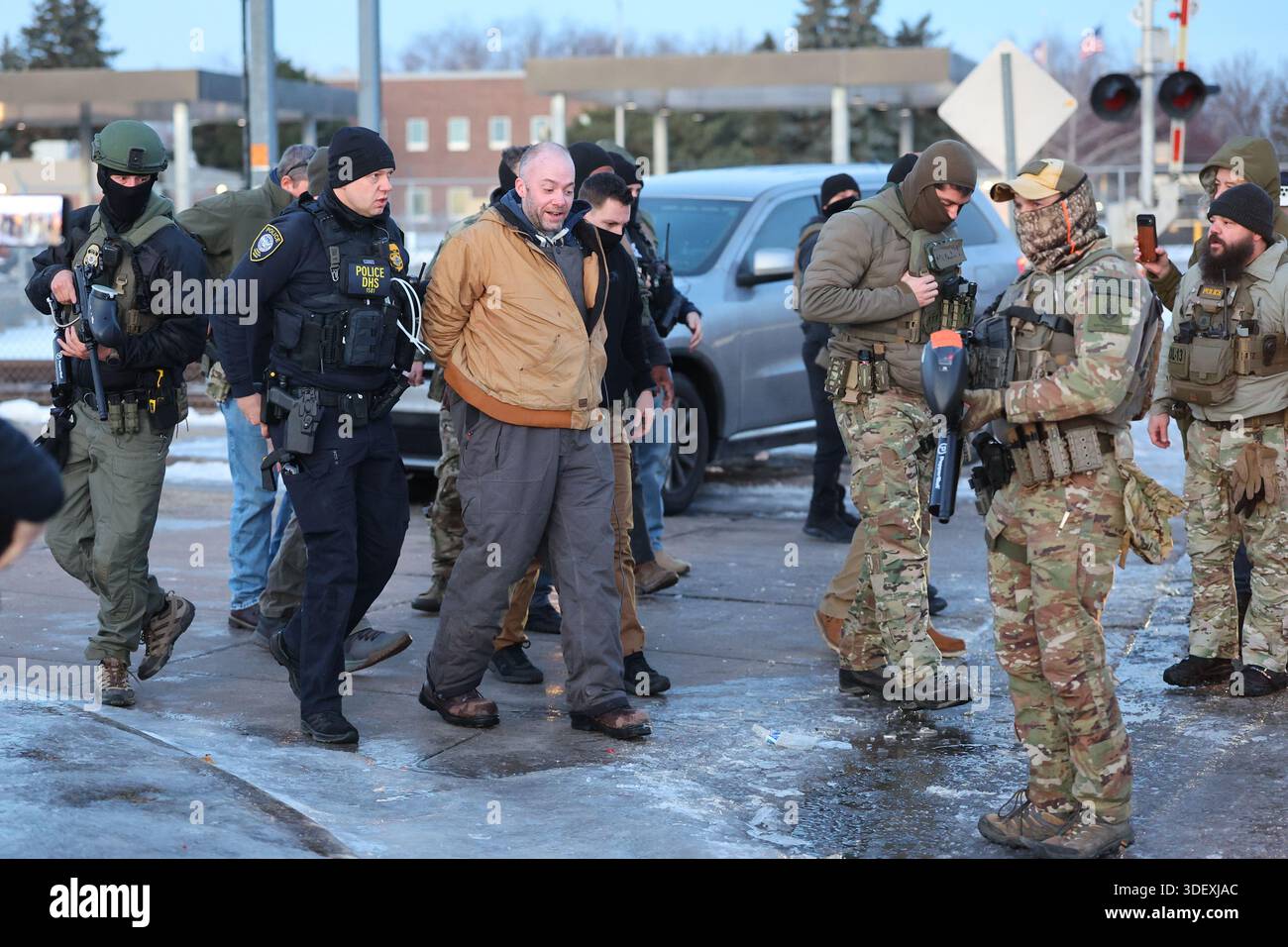 A protester is arrested by federal agents outside the Bishop Henry ...