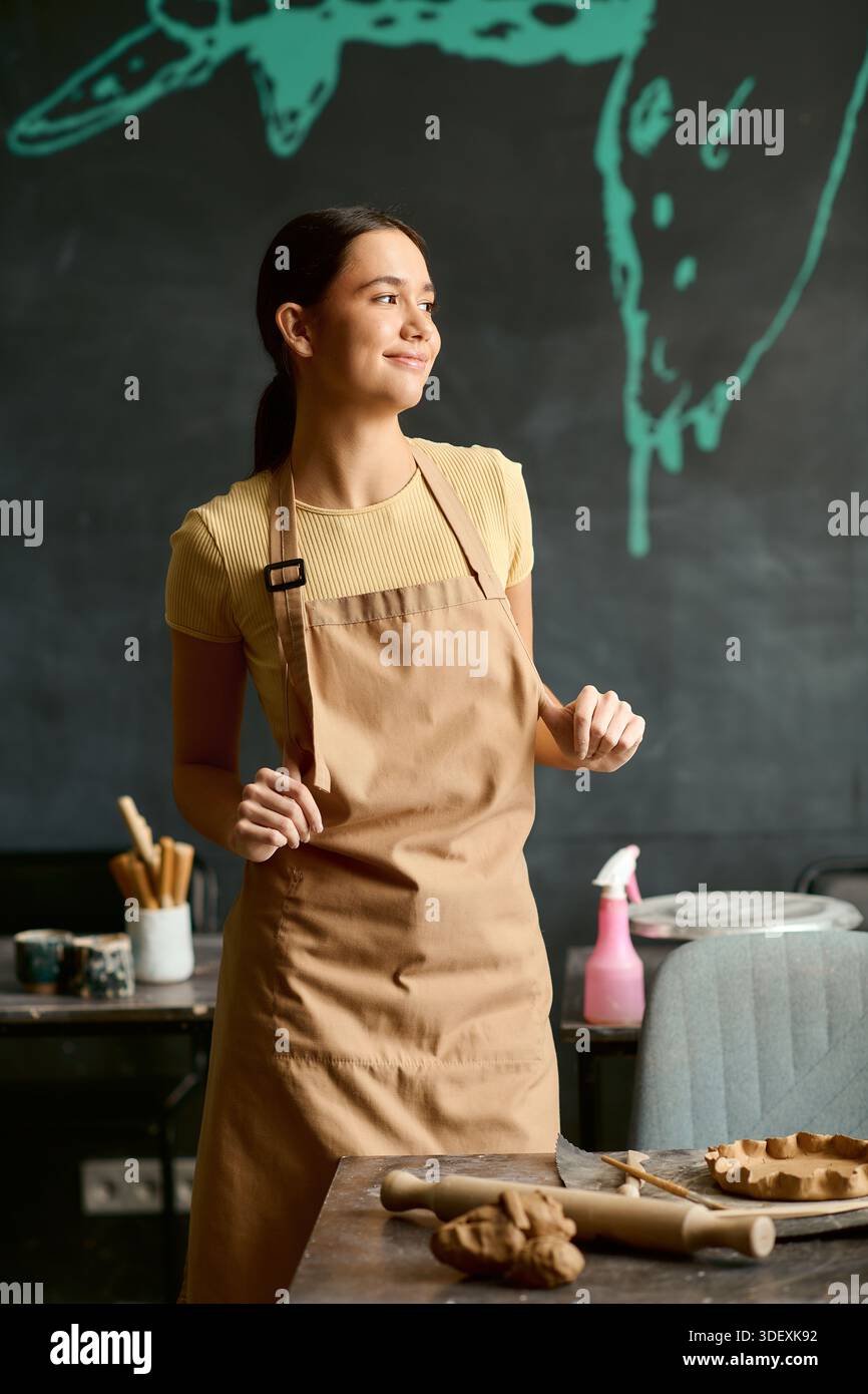 Bright smiles fill the pottery studio as a young woman crafts her ...