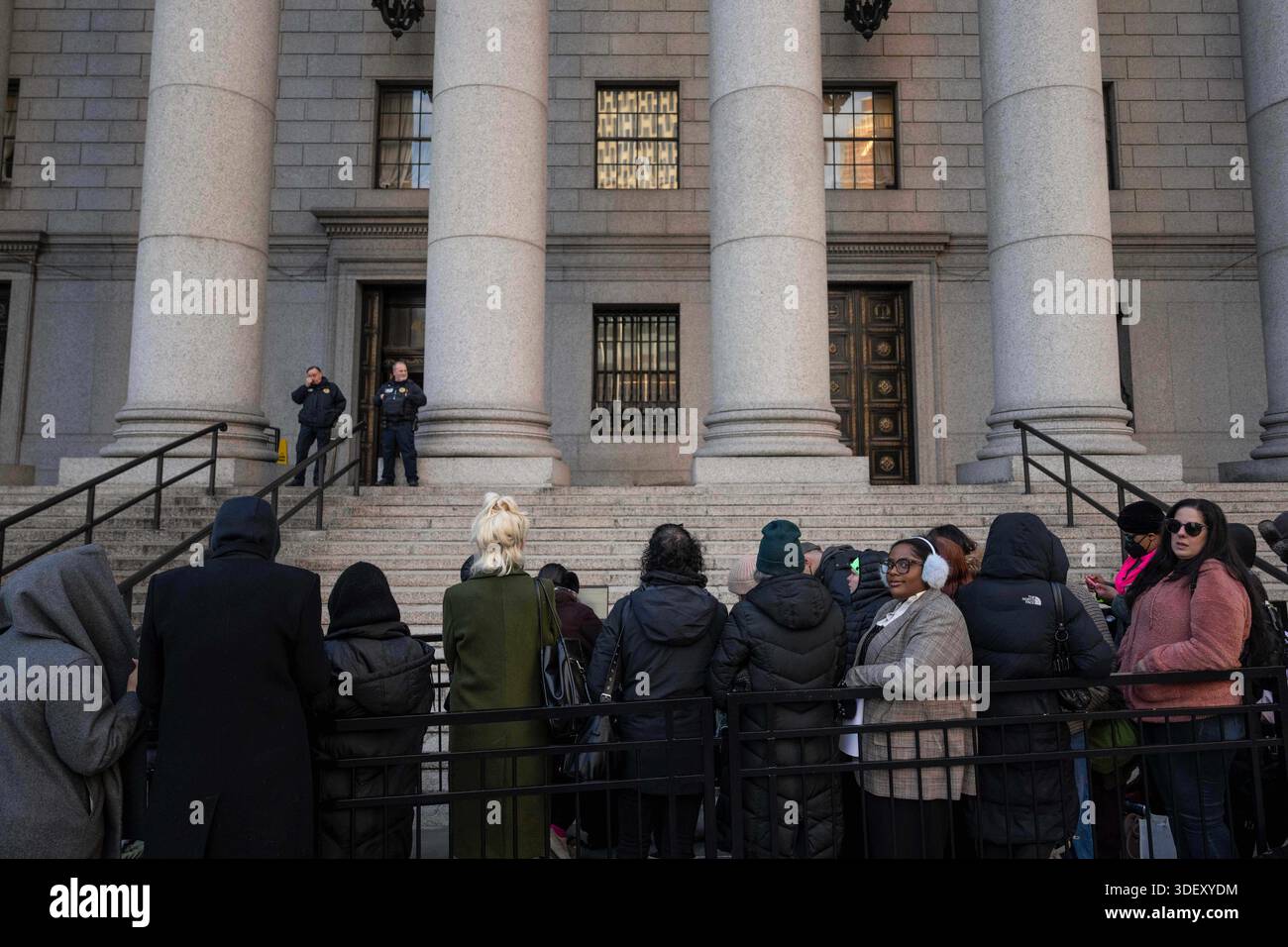 People wait in line to enter Manhattan federal court ahead of a hearing ...