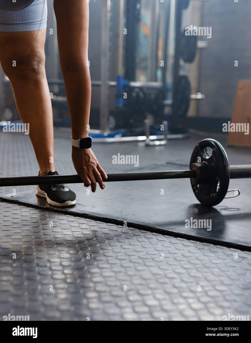 Right hand and lower body are reaching to grip loaded barbell on ...