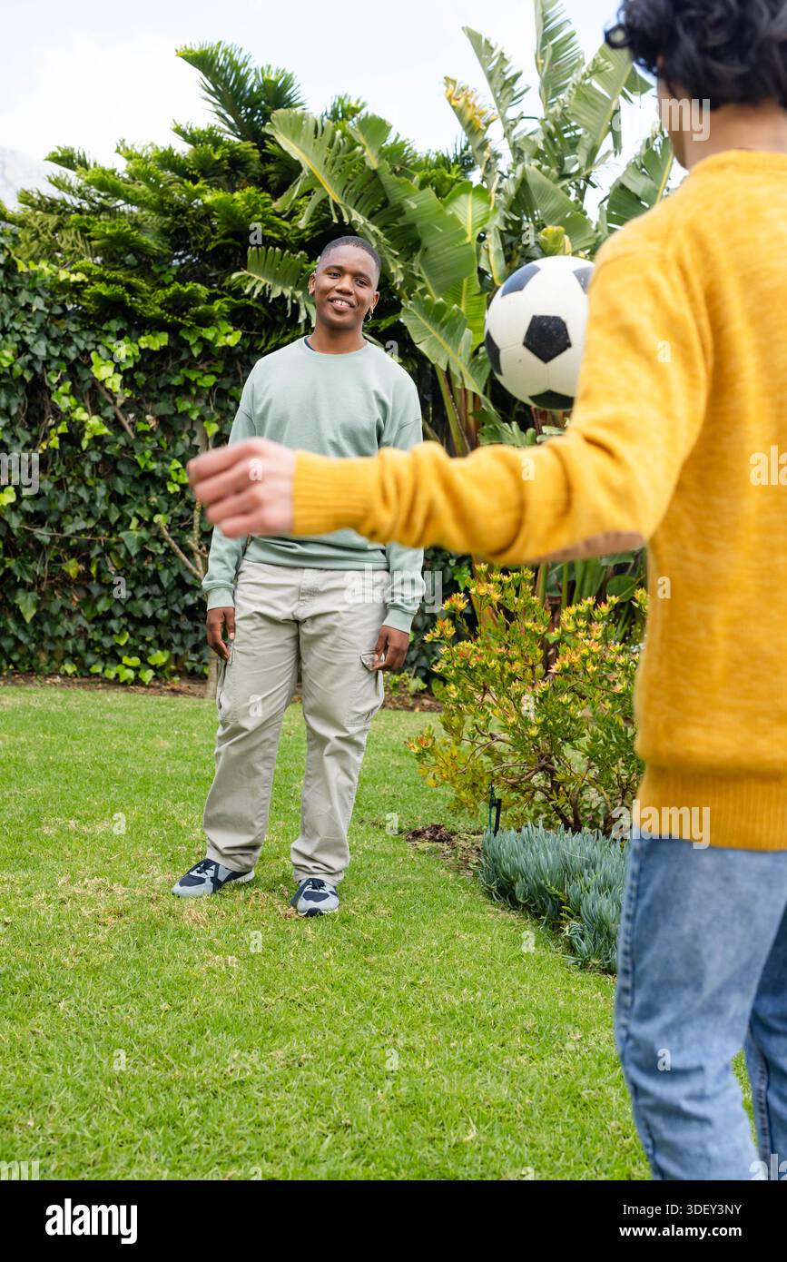 Diverse male friends kicking hi-res stock photography and images - Alamy