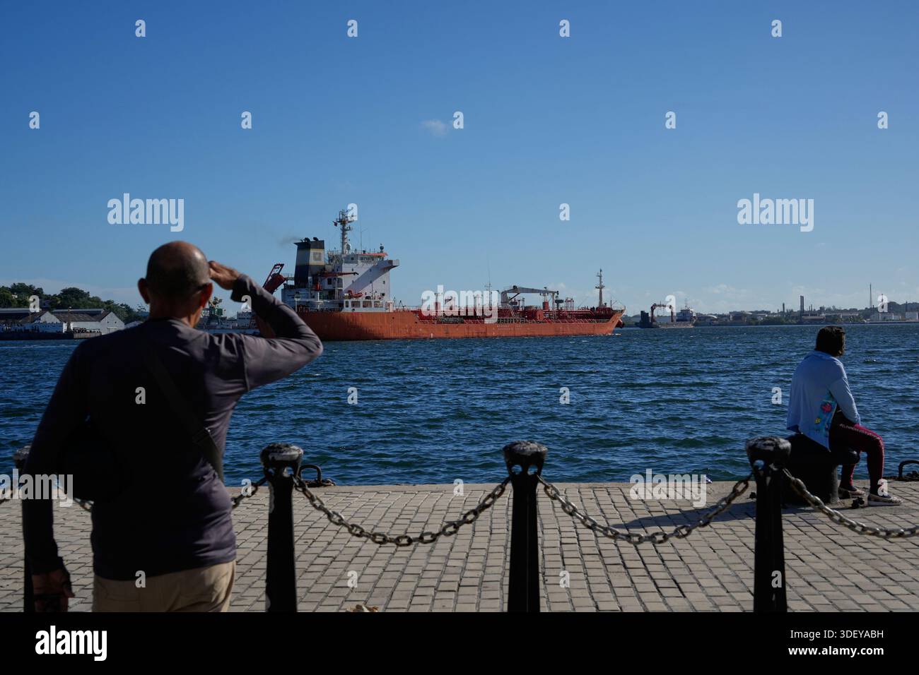 People watch the oil tanker Ocean Mariner, Monrovia, arrive to the bay ...