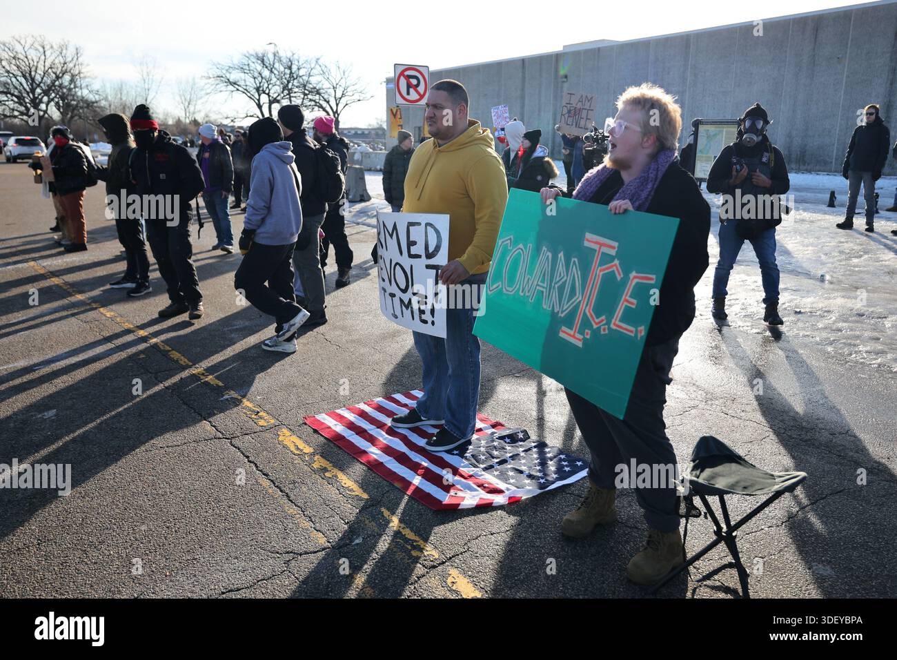 Protesters gather across the street from the Bishop Henry Whipple ...