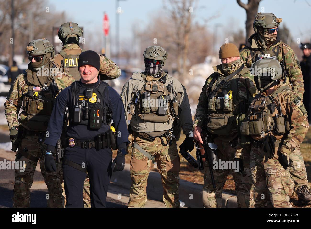 Federal agents stand outside the Bishop Henry Whipple Federal Building ...