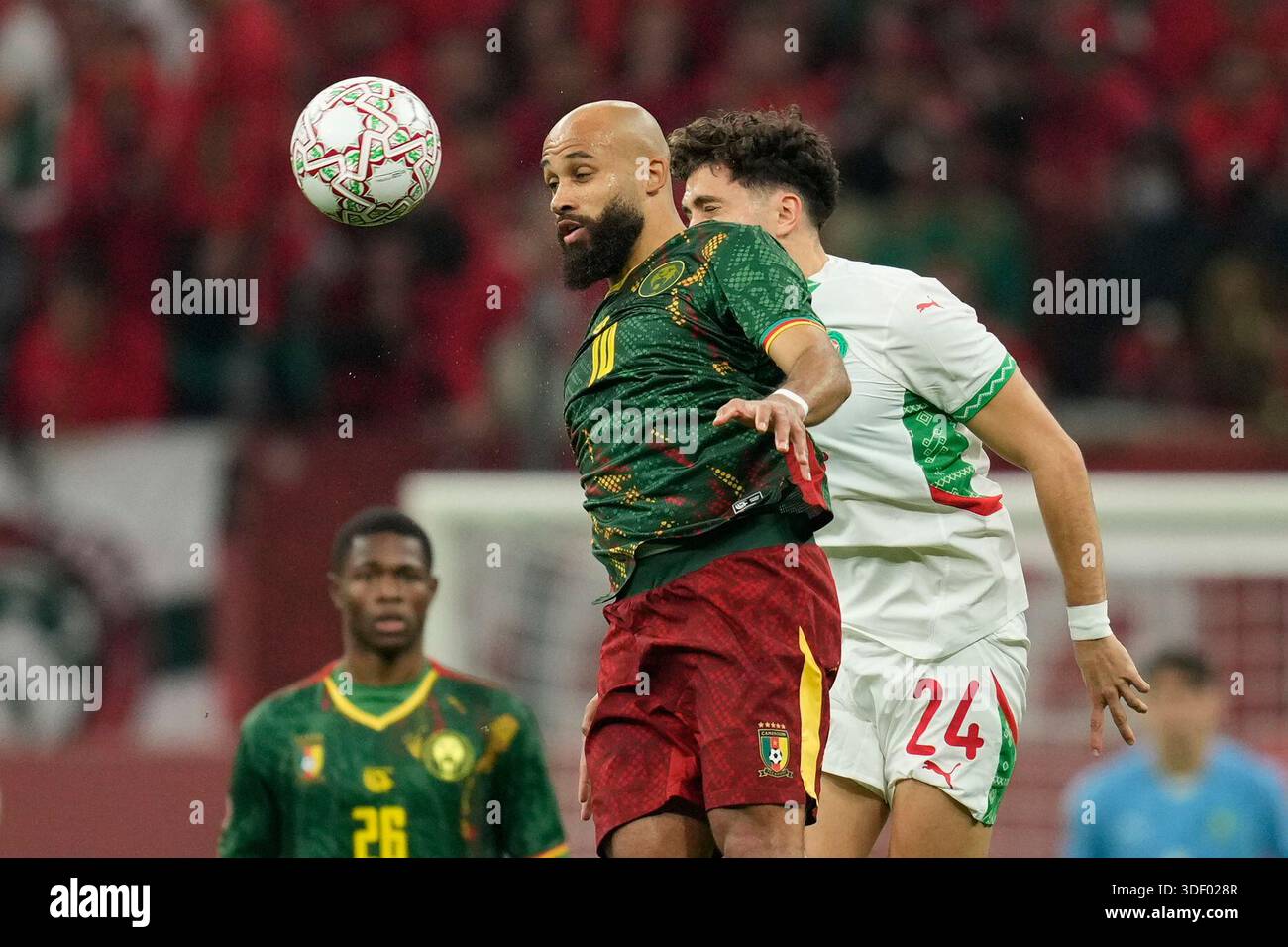 Morocco's Neil Yoni El Aynaoui, right, jumps for a header with Cameroon ...