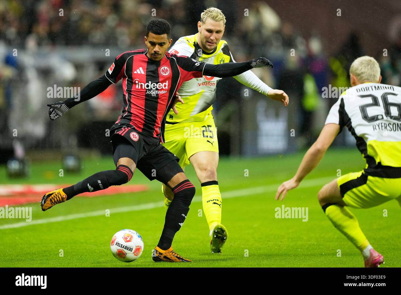 Frankfurt's Ansgar Knauff, left, kicks the ball ahead of Dortmund's ...