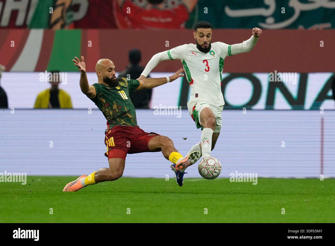 Morocco's Noussair Mazraoui, right, is challenged by Cameroon's Bryan ...