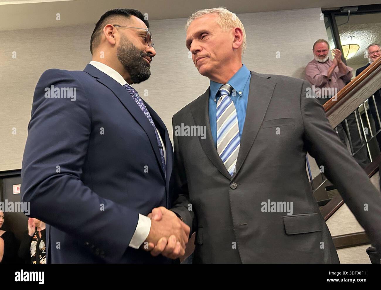 Obby Khan, left, shakes hands with Wally Daudrich after winning the ...