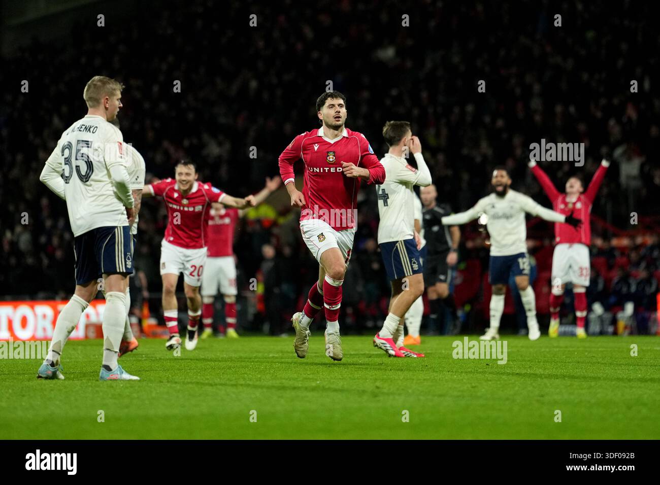 Wrexham's Liberato Cacace, center, celebrates after scoring the opening ...