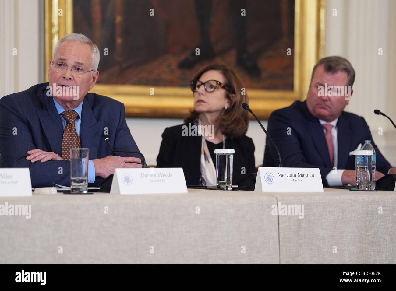 Darren Woods, CEO of ExxonMibil, left, speaks as Maryann Mannon ...