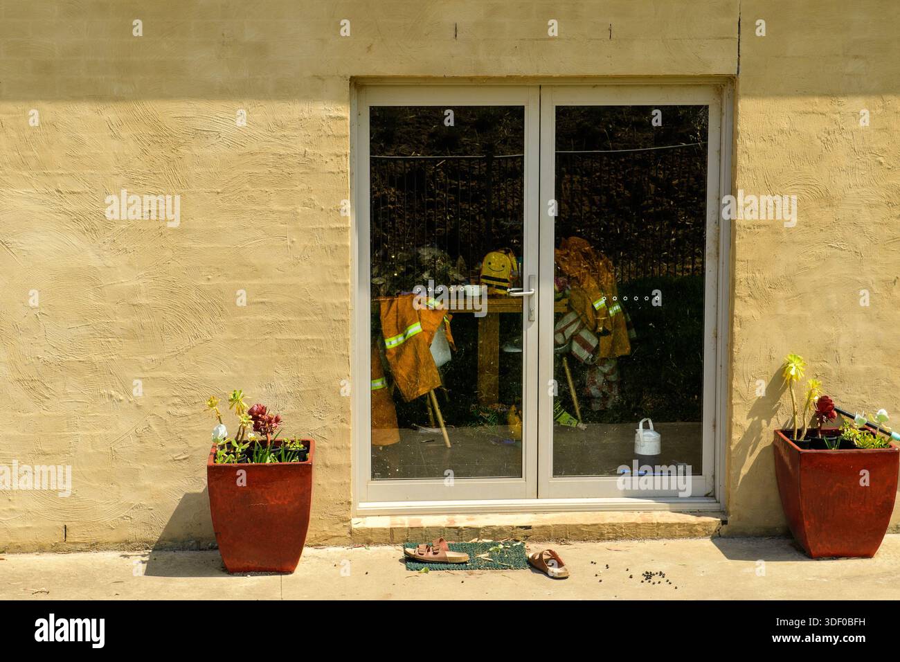 Firefighting protective clothing is visible inside a home near Yea ...